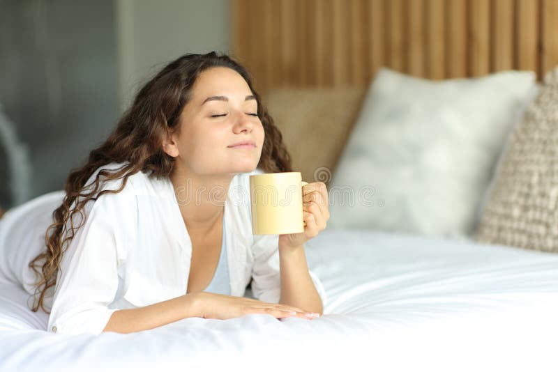 Woman on a Bed Enjoying a Cup of Coffee Stock Photo - Image of enjoying ...