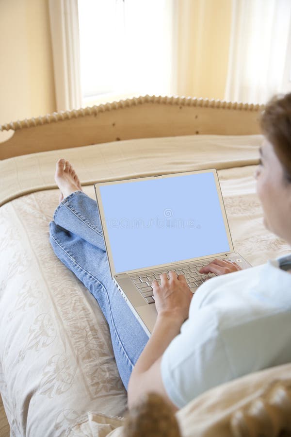 Woman on Bed with Keyboard stock image. Image of female - 28541221