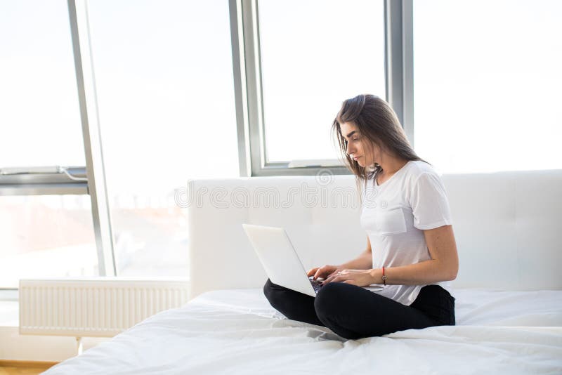 Woman in bed with laptop stock photo. Image of legs, computer - 83139346