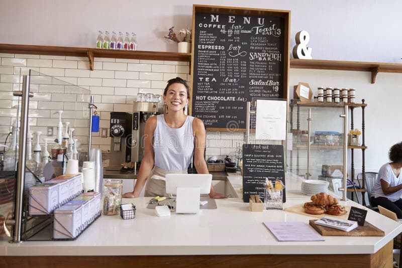 Woman Behind the Counter of a Coffee Shop Looking To Camera Stock Photo ...