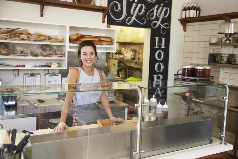 Woman At Counter In Restaurant Serving Customer Stock Photo - Image of ...