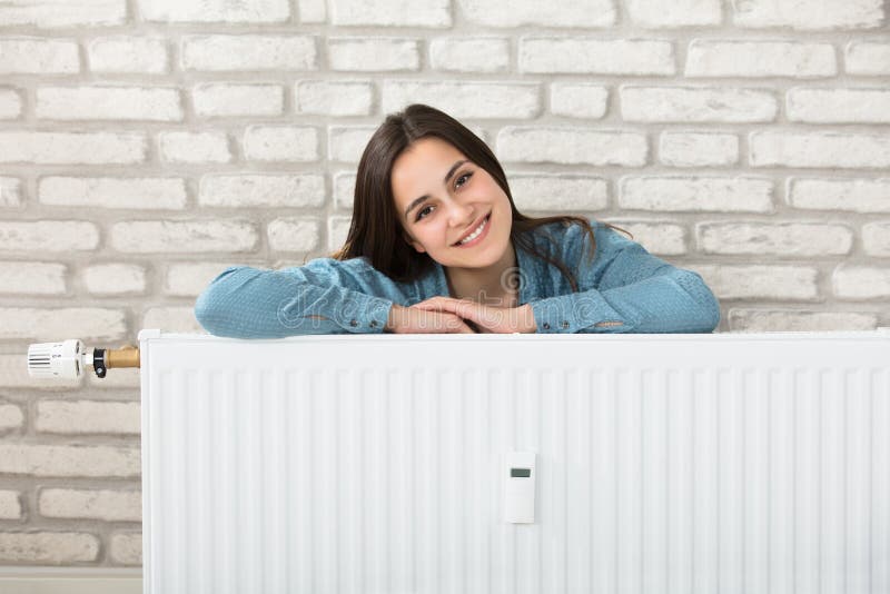 Woman Behind the Heating Radiator Stock Photo - Image of heat, budget ...