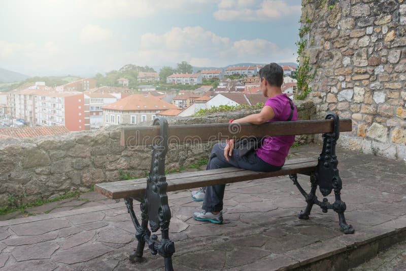 Woman from Behind Sitting on Bench Looking at Village Stock Photo ...
