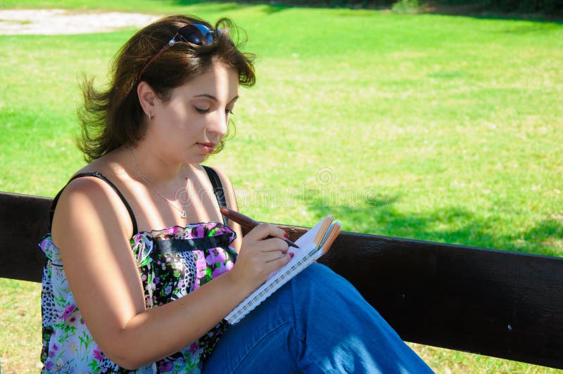 Woman on a Bench Writes into Her Notepad Stock Image - Image of ...