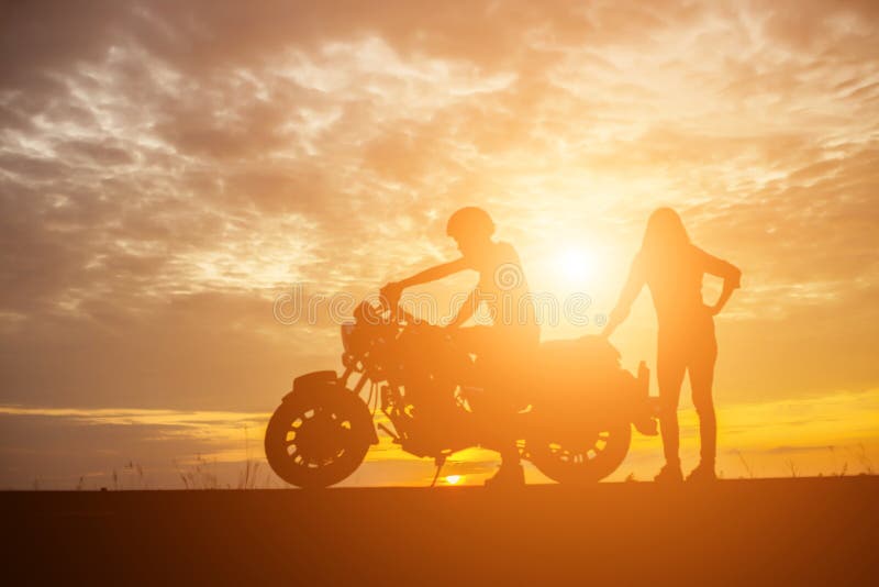 Woman biker over sunset stock image. Image of biker - 152563649