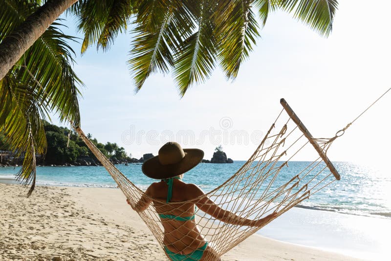 Woman in Bikini Sitting on Hammock on the Beach Stock Photo - Image of ...