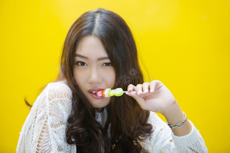 Woman biting gelatin candy stock image. Image of beauty - 51822883