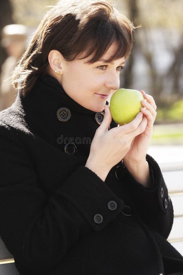 Woman in Black Smelling Apple Stock Image - Image of black, sunlight ...