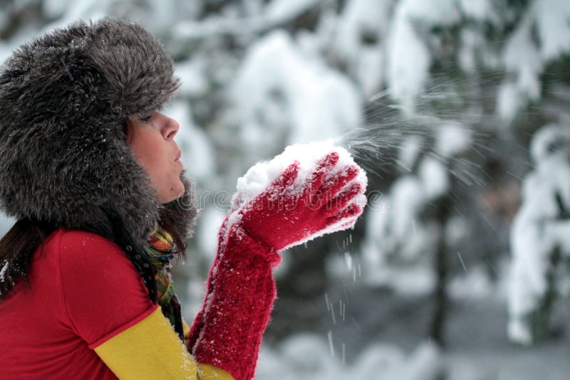 Woman Blowing the Snow in Her Hands Stock Photo - Image of adult, snow ...