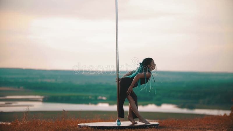 Woman with Blue Braids Dancing by the Pole - Bending Down Stock Video ...