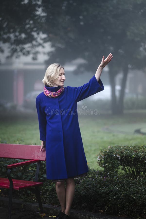 Woman in a Blue Coat Near a Park Bench. Stock Image - Image of cute ...