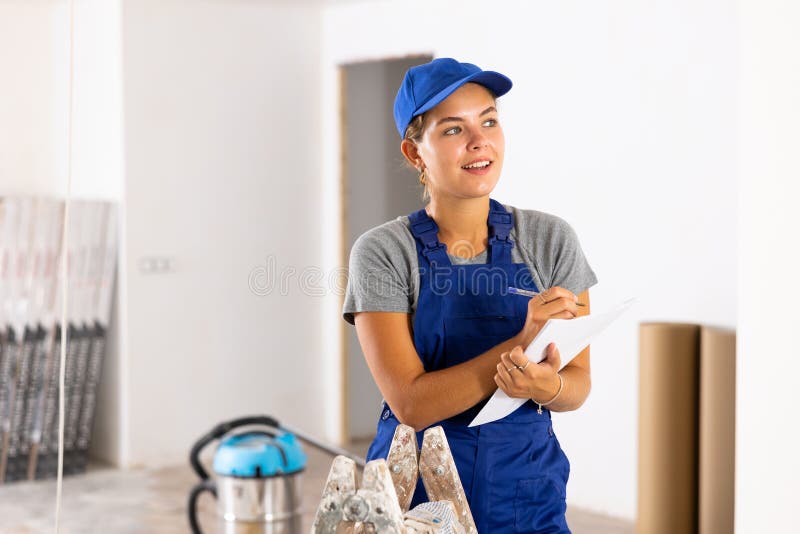Woman in Blue Overalls Checking Completed Construction Work on Drawing ...