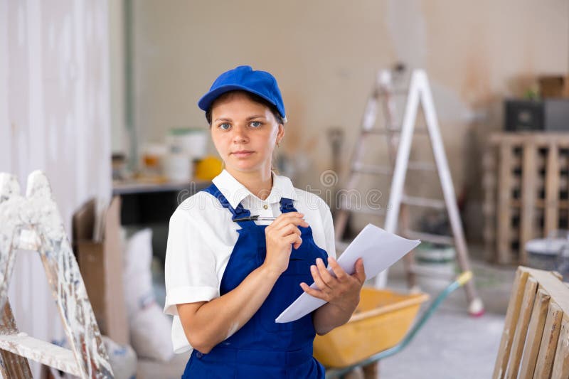 Woman in Blue Overalls Checking Completed Construction Work on Drawing ...