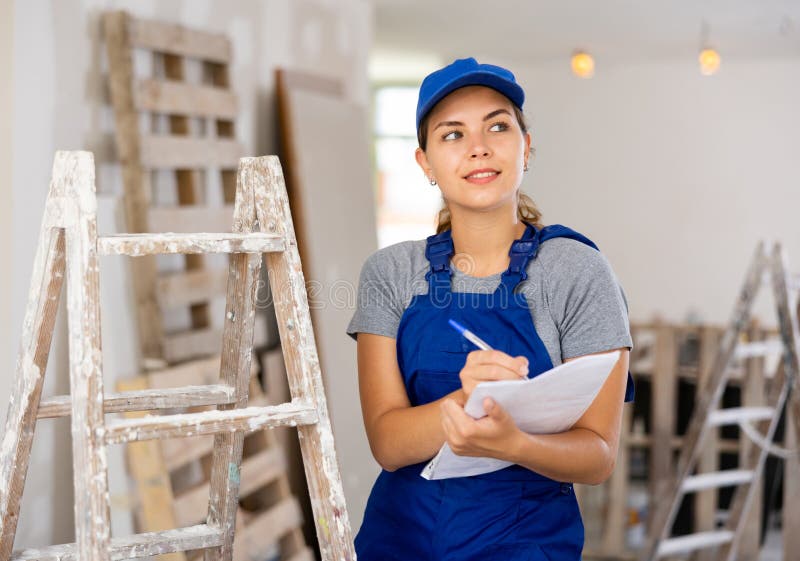 Woman in Blue Overalls Checking Completed Construction Work on Drawing ...