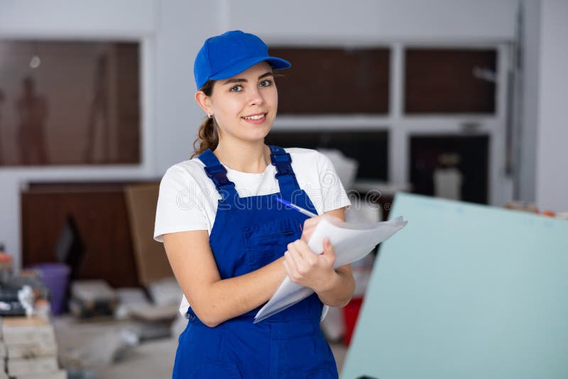 Woman in Blue Overalls Checks the Completed Construction Work on ...