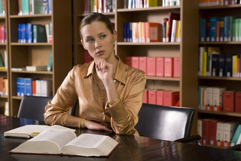 Woman with Book at Desk in Library Stock Photo - Image of adult ...