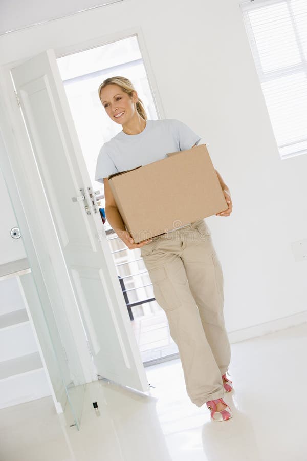 Woman with Box Moving into New Home Smiling Stock Image - Image of ...
