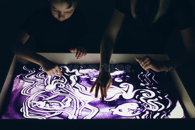 Woman and a Boy Draw on an Interactive Sand Table Stock Image - Image ...