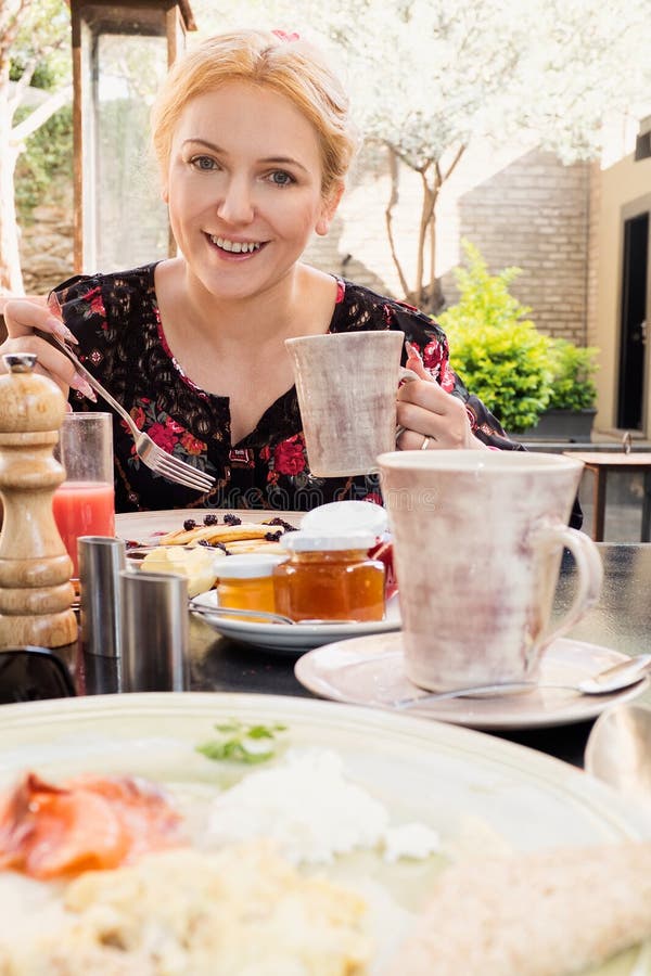 Woman at breakfast stock photo. Image of breakfast, outside - 34259072