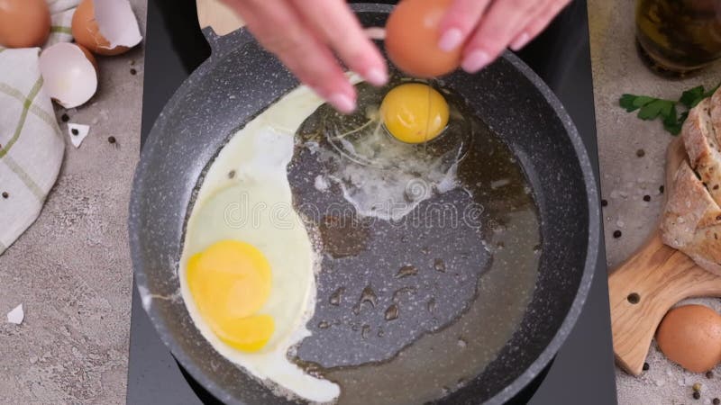 Woman Breaks Egg into Hot Frying Pan on Stove Stock Video - Video of ... Woman Breaks Egg into Hot Frying Pan on Stove Stock Video - Video of ...