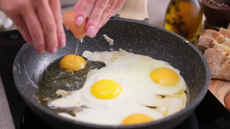 Woman Breaks Egg into Hot Frying Pan on Stove Stock Footage - Video of ... Woman Breaks Egg into Hot Frying Pan on Stove Stock Footage - Video of ...