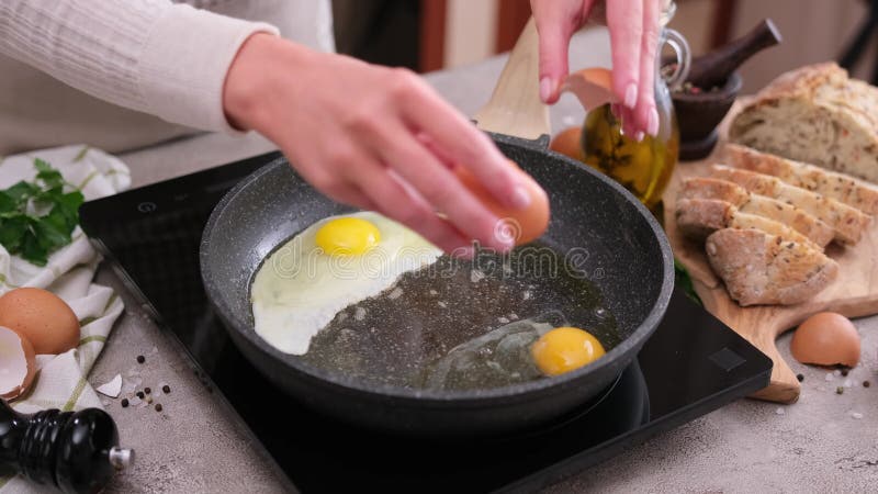 Woman Breaks Egg into Hot Frying Pan on Stove Stock Footage - Video of ... Woman Breaks Egg into Hot Frying Pan on Stove Stock Footage - Video of ...
