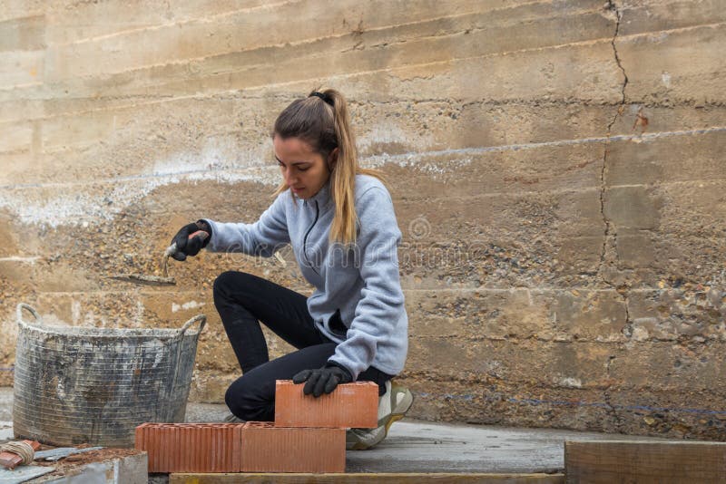 Woman Bricklayer Preparing Laying Bricks To Build Her Own House Stock ...