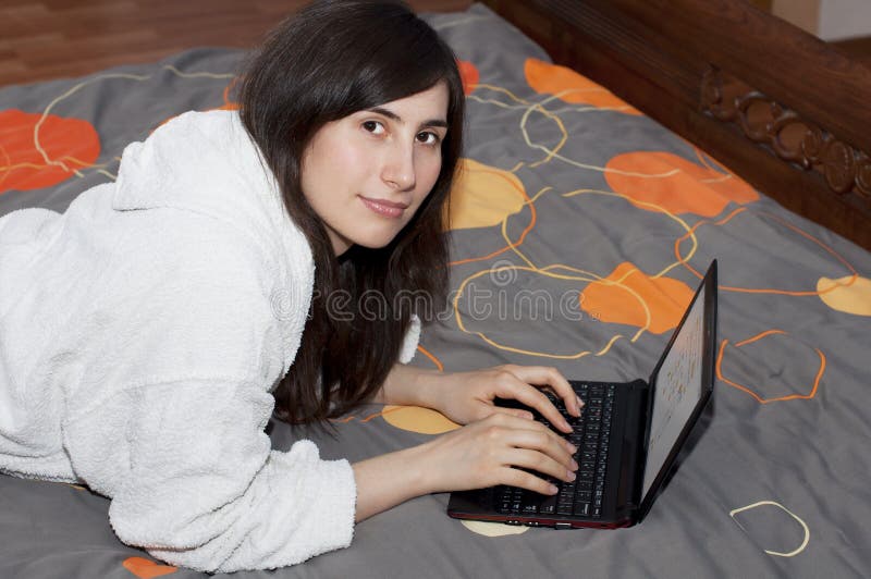 Woman Browsing the Internet while Lying in Bed Stock Image - Image of ...