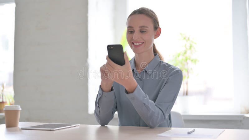 Woman Browsing Internet on Smartphone in Office Stock Photo - Image of ...