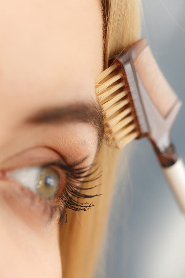 Woman Brushing Her Eyebrows Stock Image - Image of young, eyebrow ...