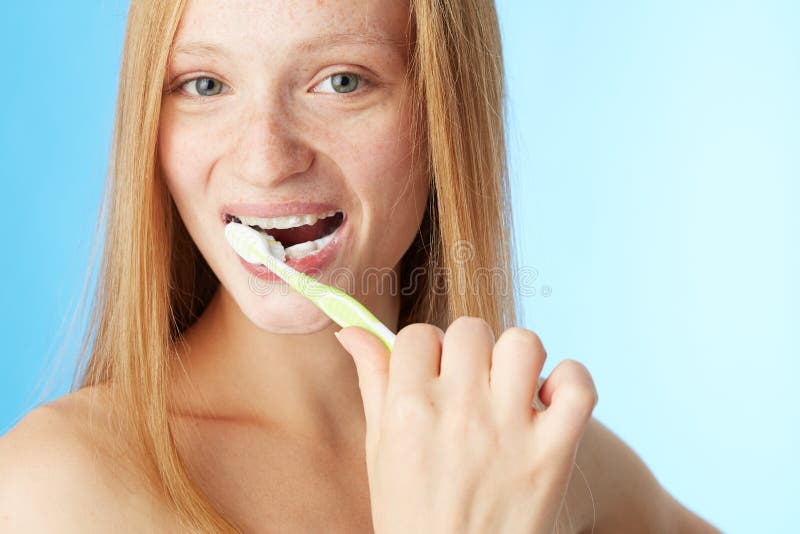 Woman brushing teeth stock image. Image of dental, blue - 49079269