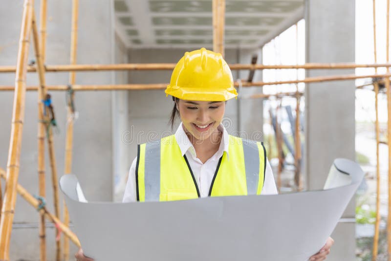Woman Builder with Floor Plan Looking Construction Blueprint Happy ...