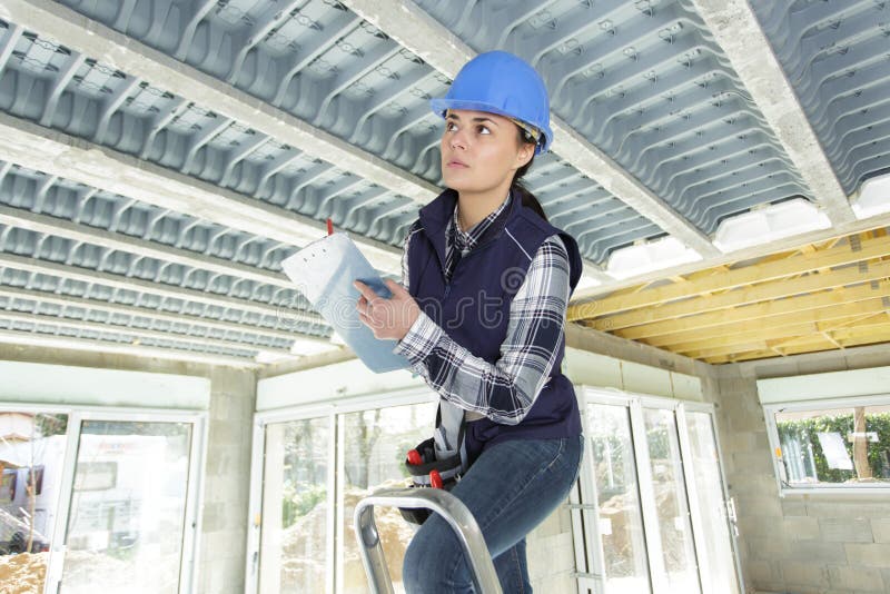 Woman builder on ladder stock photo. Image of improvement - 232038198