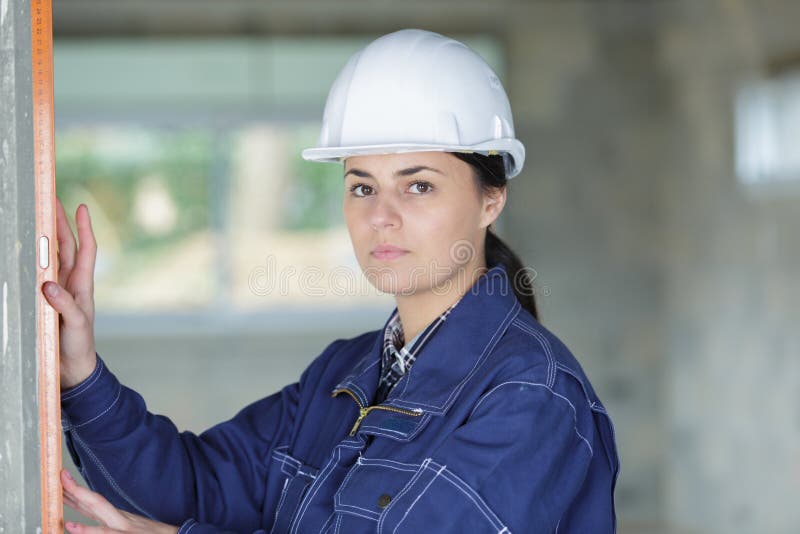 Woman Builder with Level in New Building Stock Image - Image of helmet ...