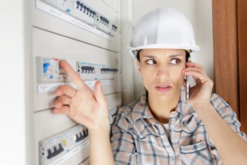 Woman Builder on Phone Measuring Electrical Current Stock Image - Image ...