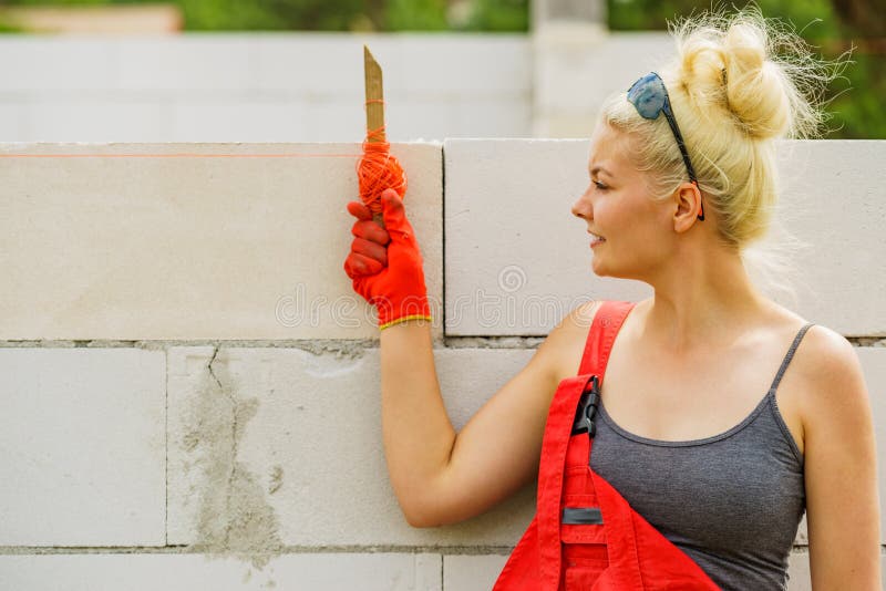 Woman Using String As Level in Wall Construction Stock Image - Image of ...