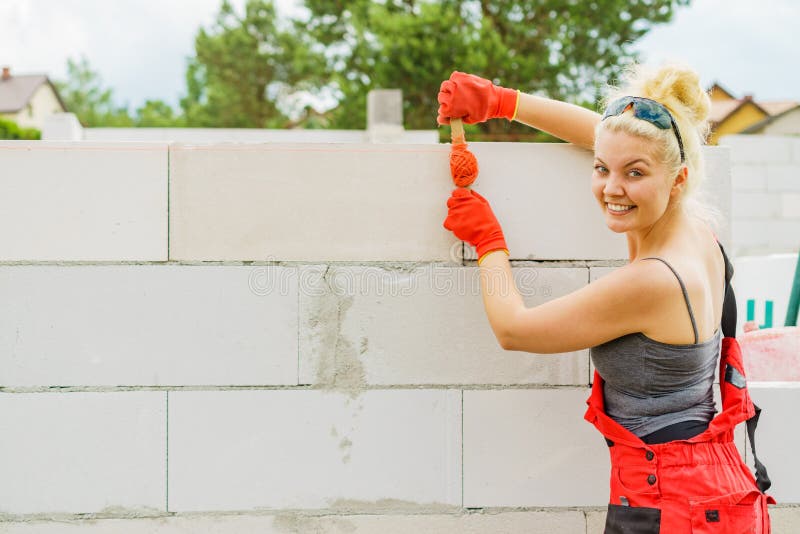 Woman Using String As Level in Wall Construction Stock Photo - Image of ...