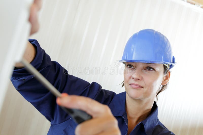 Woman Builder Working Using Screwdriver and Fix Door Stock Photo ...
