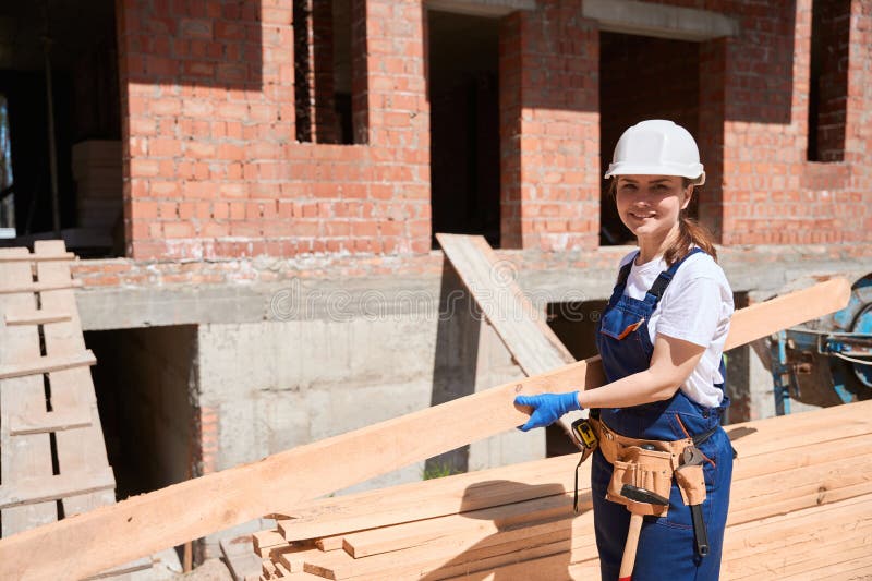 Woman Building Engineer in Uniform and Toolbelt Holding Timber Girder ...