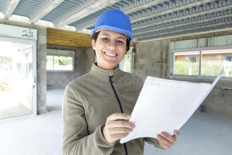Woman on Building Site Holding Paperwork Stock Image - Image of ...
