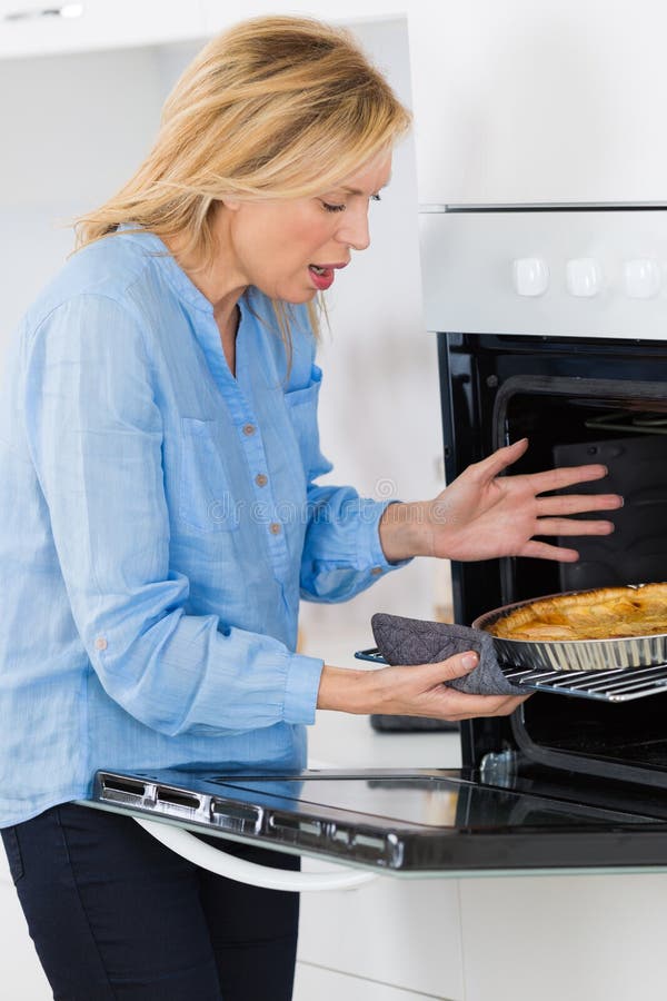 Woman Burns Hands while Removing Hot Pie from Oven Stock Photo - Image ...