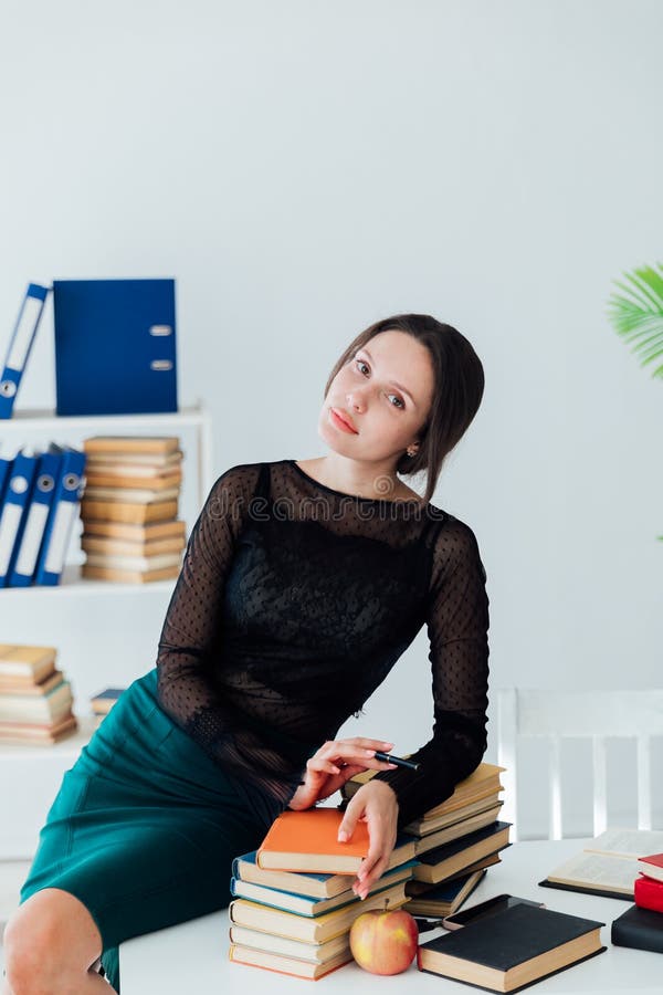 Woman in Business Suit Sitting on Office Desk with Books Stock Photo ...