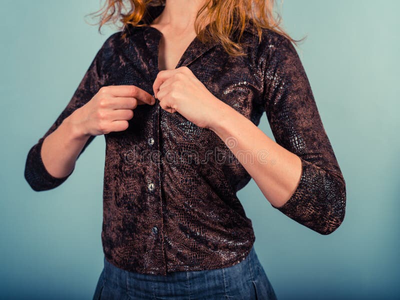 Woman buttoning her shirt stock photo. Image of clothes - 51146148