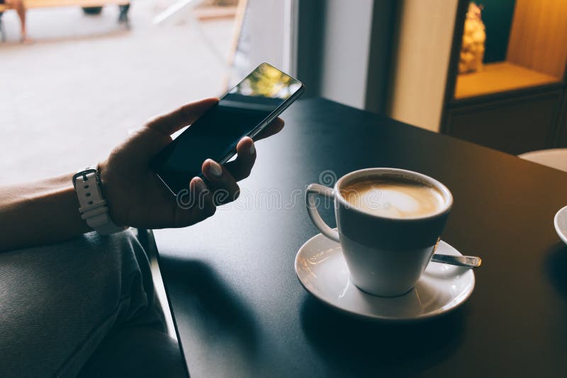 Woman in a Cafe Using a Mobile Phone and Drinking Coffee Stock Image ...