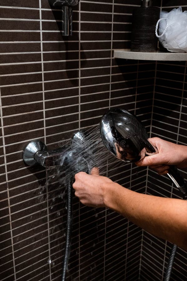 Woman Calibrating the Water Temperature and Cleaning the Shower ...