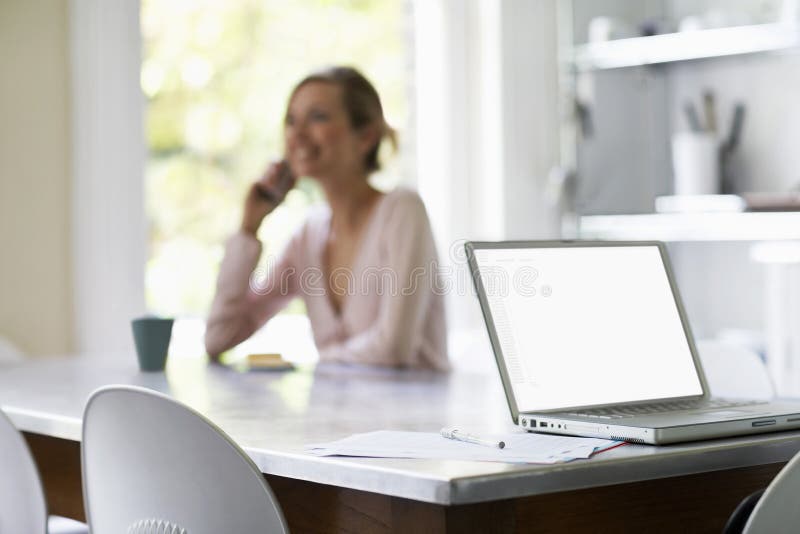 Woman on Call with Laptop and Documents on Table Stock Image - Image of ...