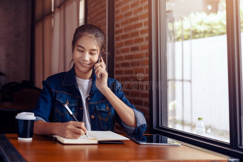 Woman Call by Phone and Makes a Note in Notebook Stock Photo - Image of ...
