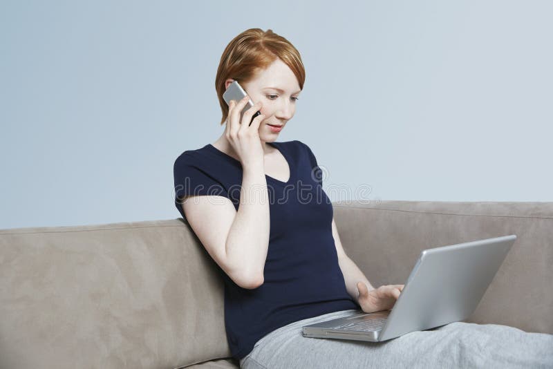 Woman on Call while Using Laptop Stock Image - Image of comfort ...