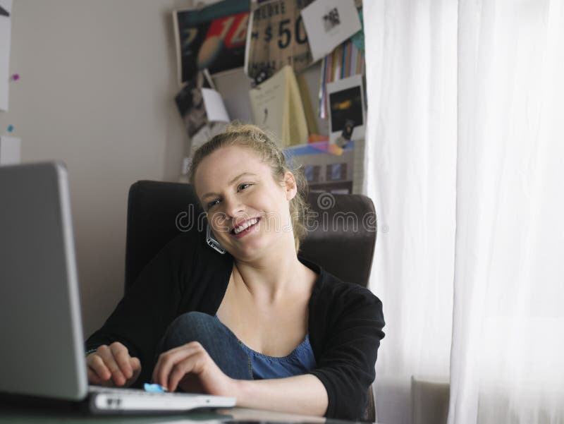 Woman on Call while Using Laptop at Desk Stock Image - Image of person ...