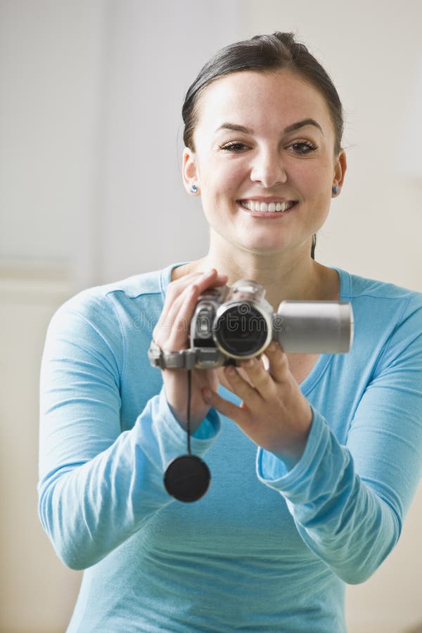 Woman with Camcorder stock photo. Image of standing, video - 10321064